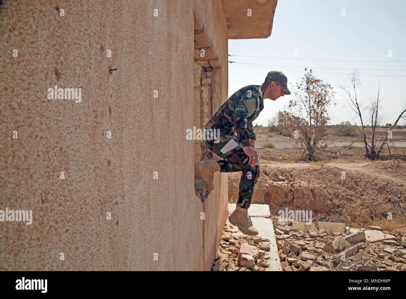An Iraqi army ranger follows his company commander in an advance of an ...