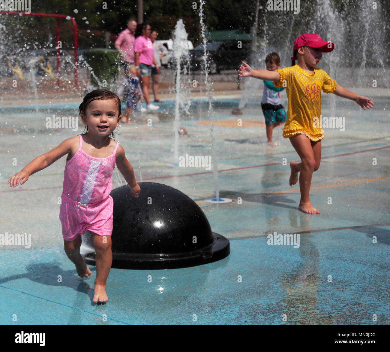 Arya Boothby runs through the splash pad during Army Materiel Command's ...