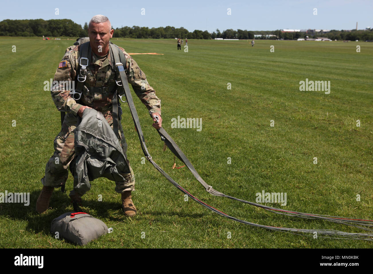 U.S. Army paratrooper packs his MC-6 parachute on Castle drop zone ...