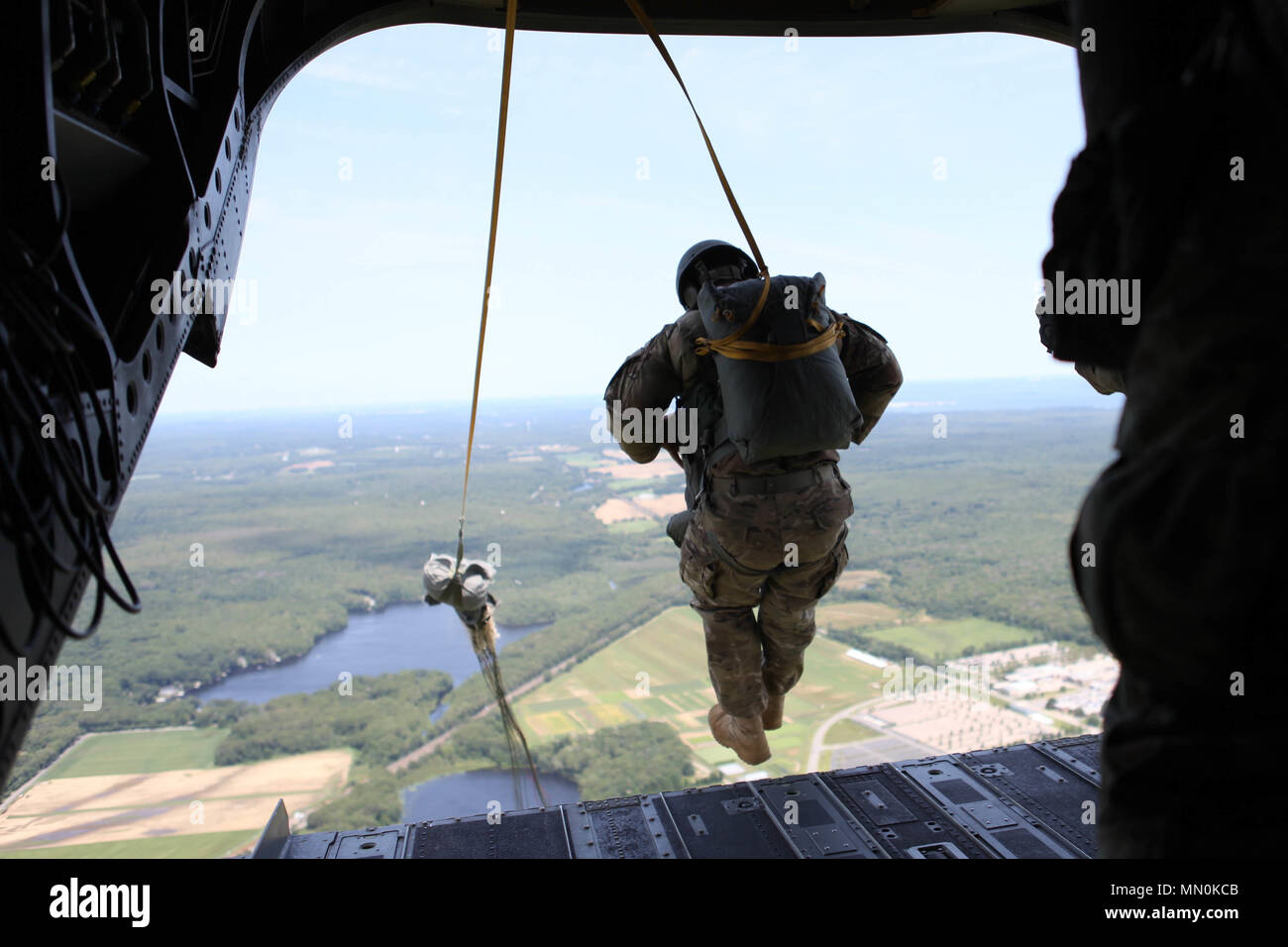 U.S. Army paratrooper jumps out of a CH-47 Chinook Helicopter during ...