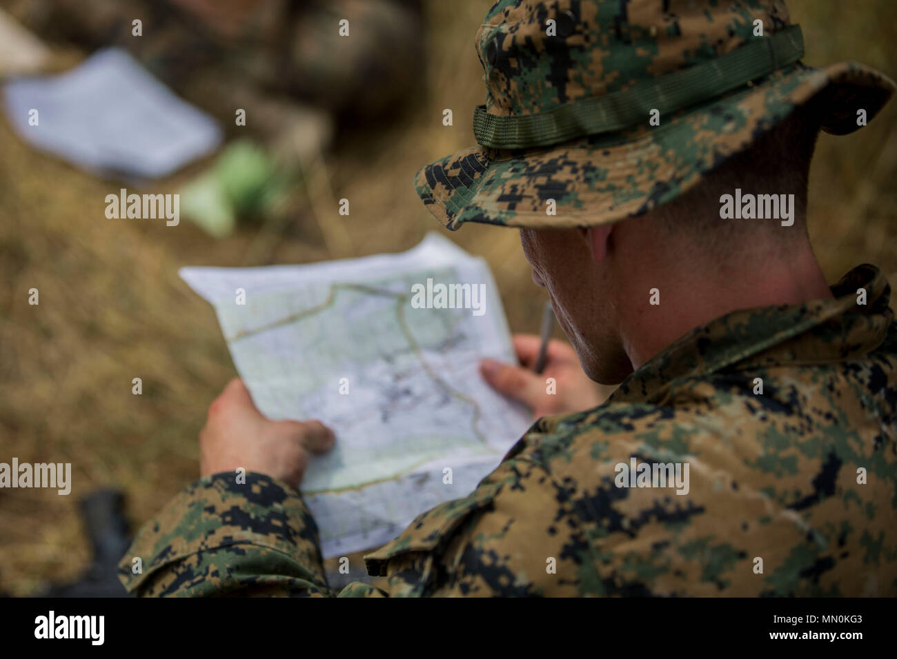 A U.S. Marine with Black Sea Rotational Force 17.1 plots points on a ...