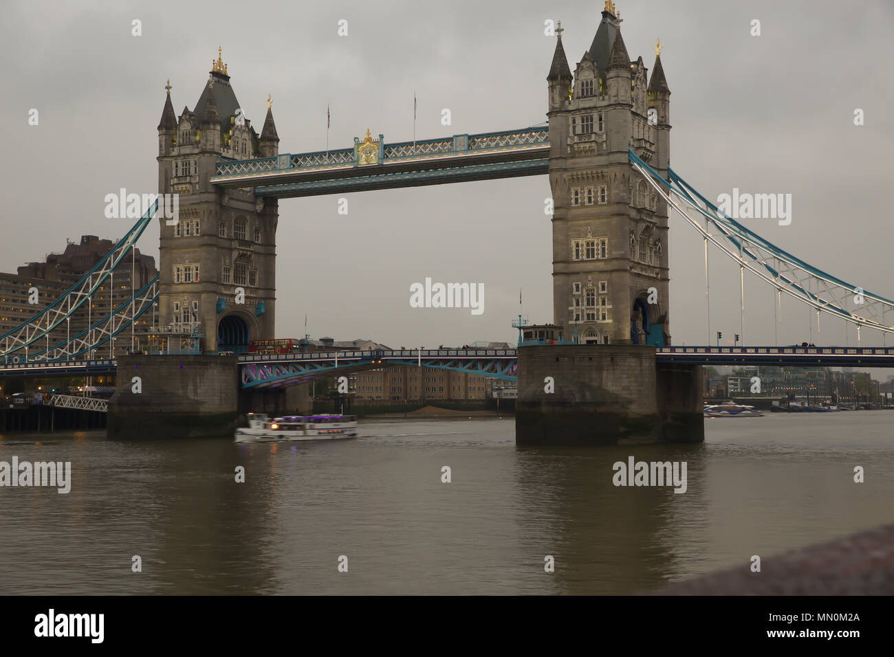 Tower Bridge lifting up early evening to allow a boat to pass ...