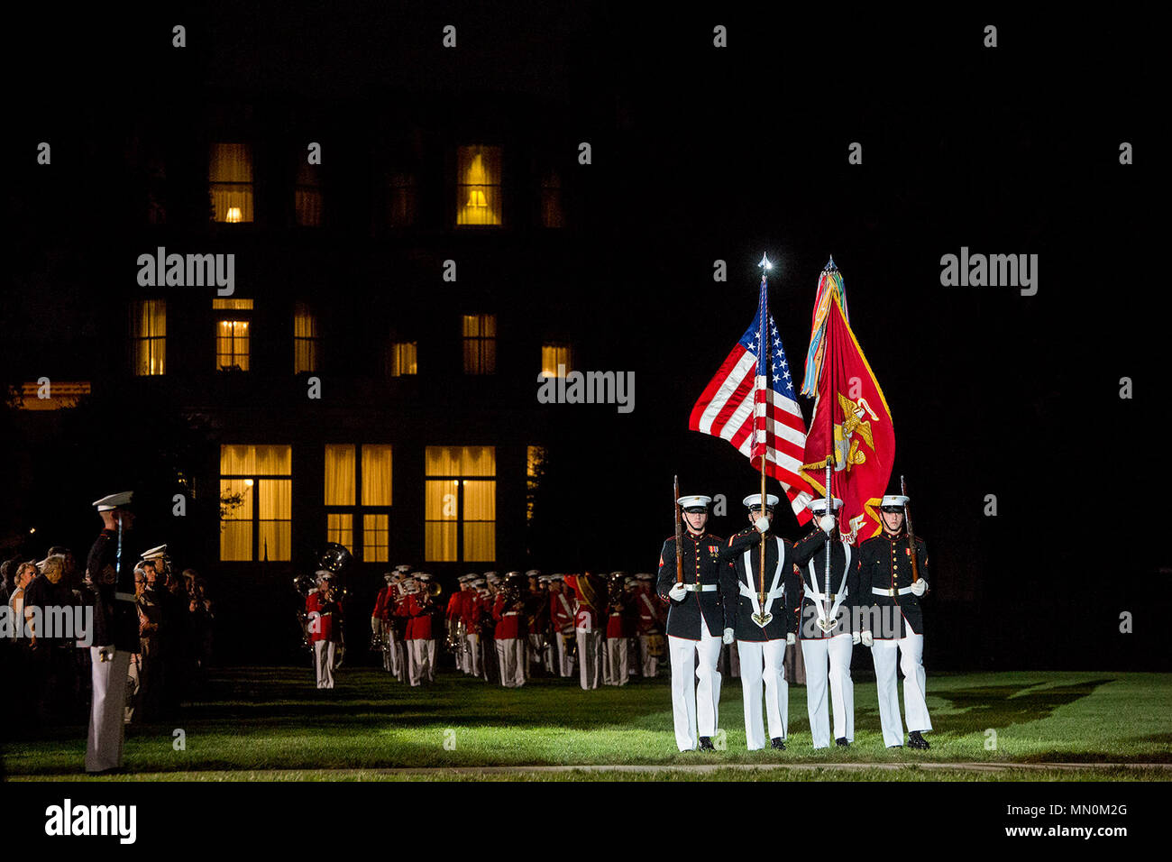 The U.S. Marine Corps Color Guard marches across the parade deck during ...