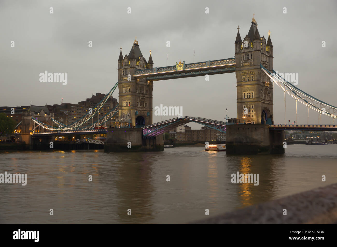 Tower Bridge lifting up early evening to allow a boat to pass ...