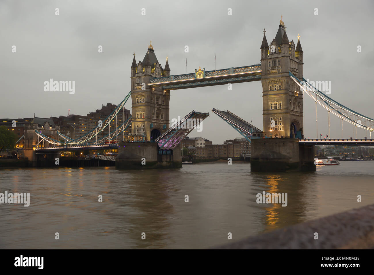 Tower Bridge lifting up early evening to allow a boat to pass ...