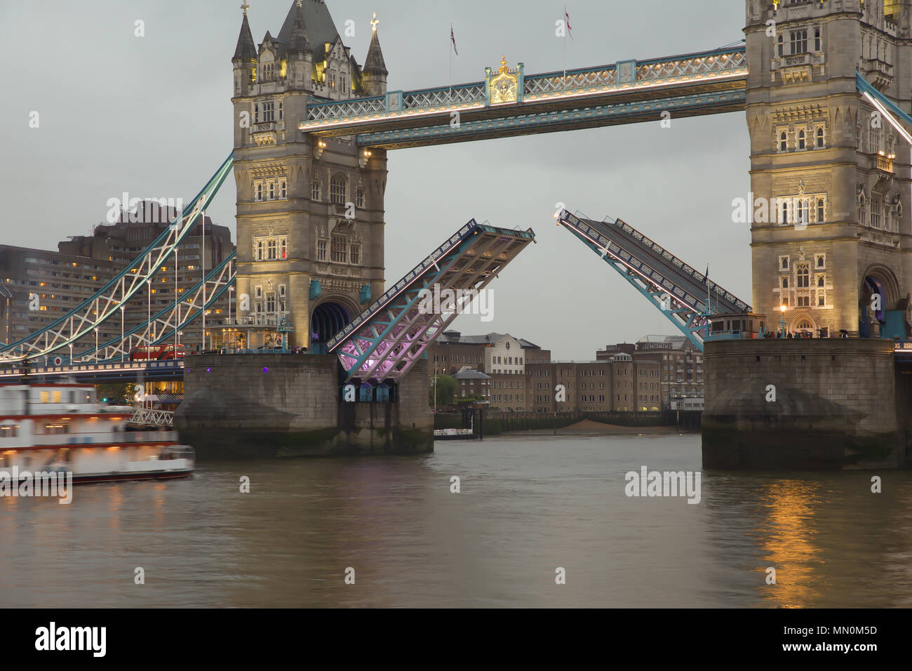 Tower Bridge lifting up early evening to allow a boat to pass ...