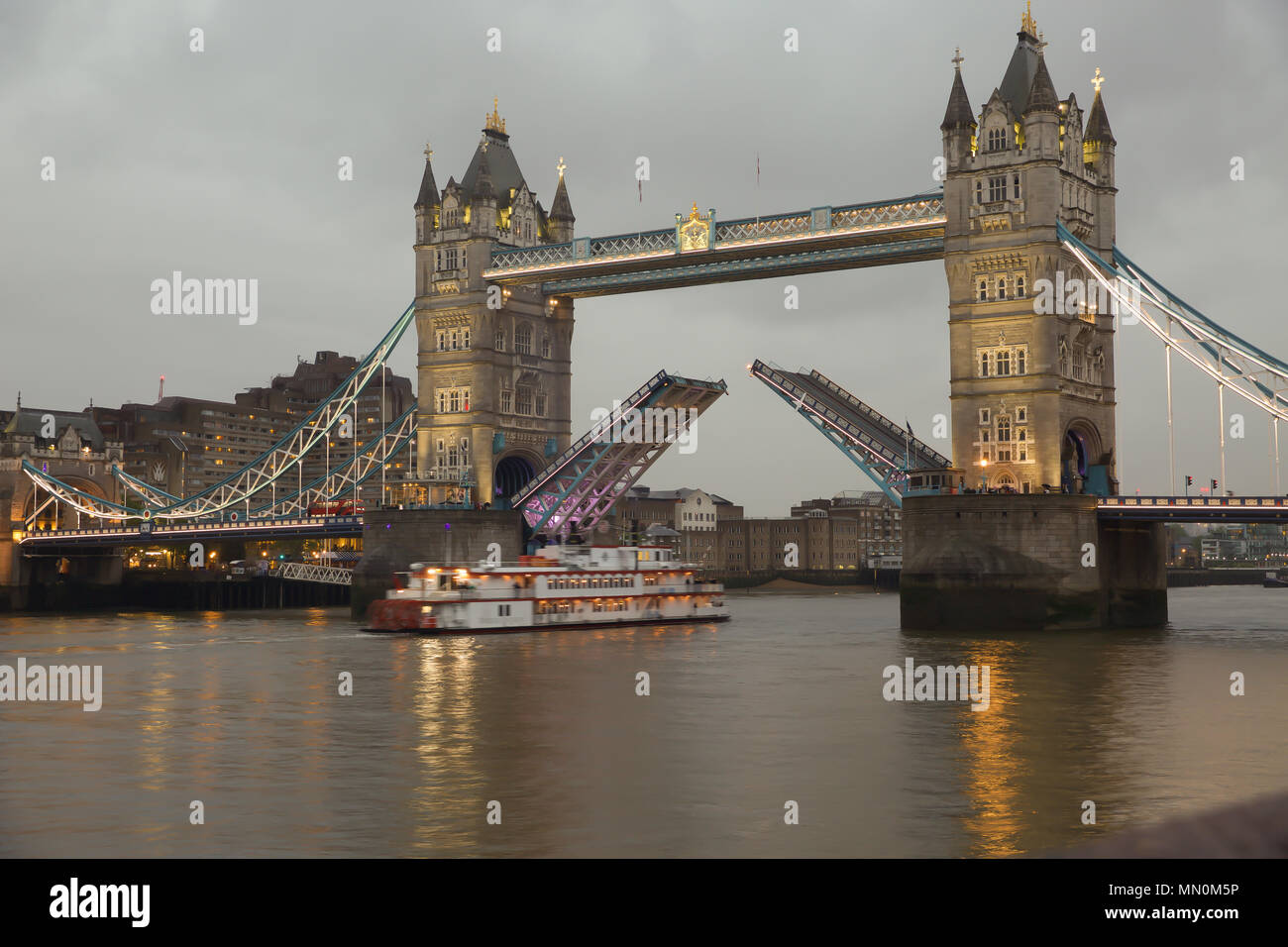 Tower Bridge lifting up early evening to allow a boat to pass ...