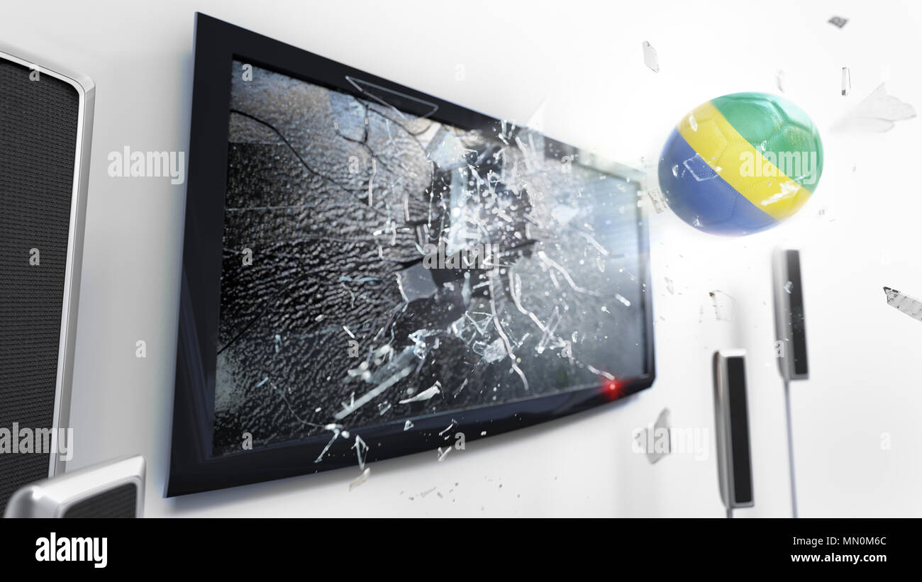 Soccer ball with the flag of Gabon flying through a shattering tv ...