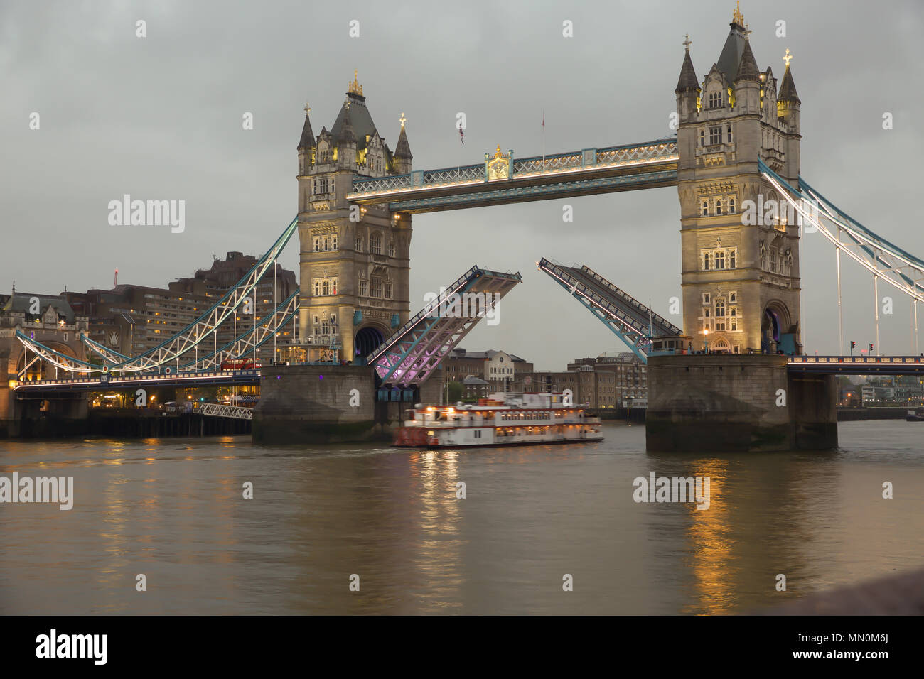 Tower Bridge lifting up early evening to allow a boat to pass ...