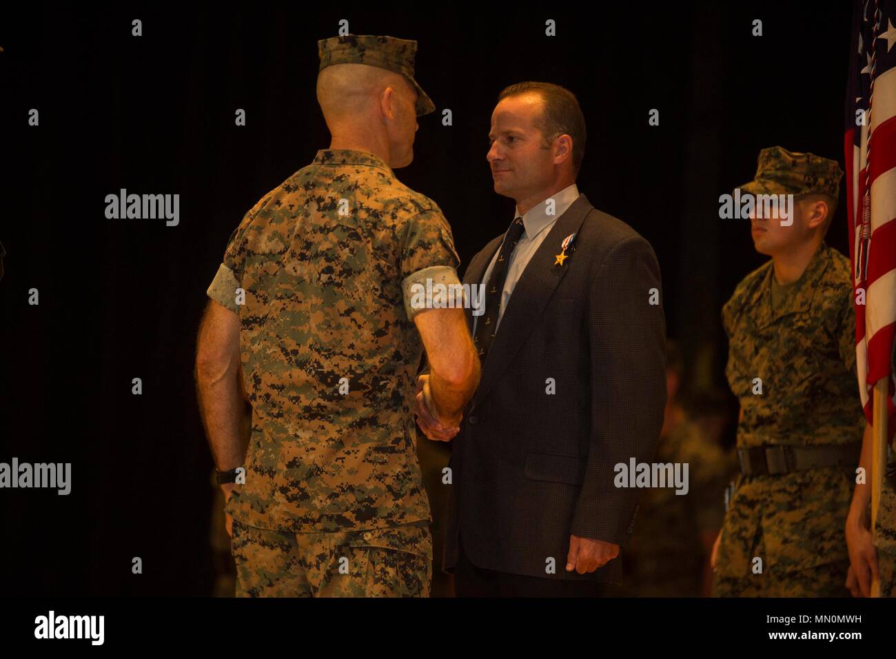 Retired U.S. Marine Corps Maj. Michael S. Seely shakes hands with U.S ...