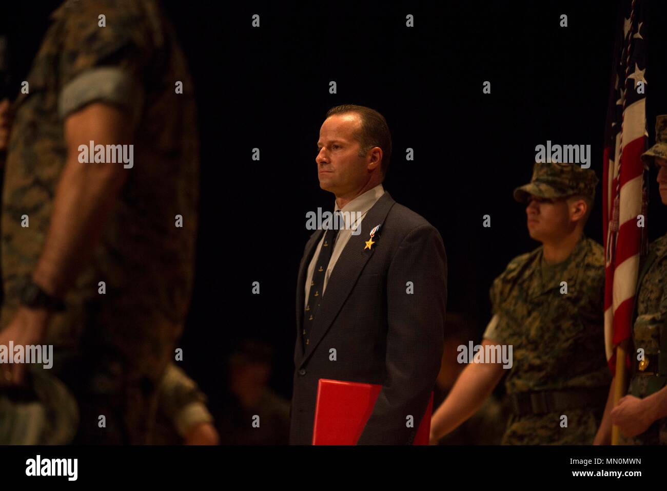 Retired U.S. Marine Corps Maj. Michael S. Seely stands at ease while U ...