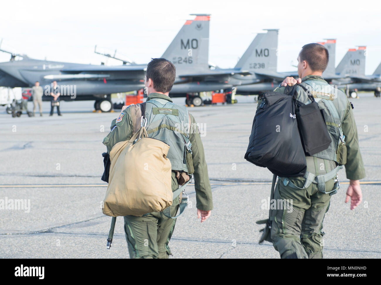 391st Fighter Squadron pilots and weapons systems officers walk toward ...