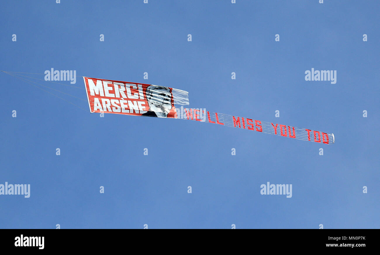 A banner honouring outgoing Arsenal manager Arsene Wenger being pulled ...