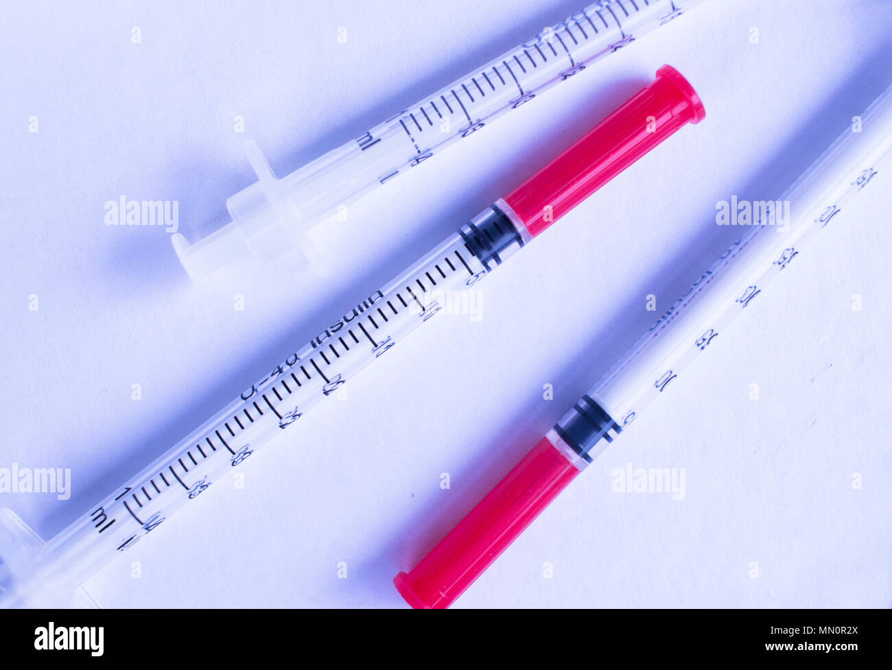 Medical syringe for injections isolated in red and white for insulin ...