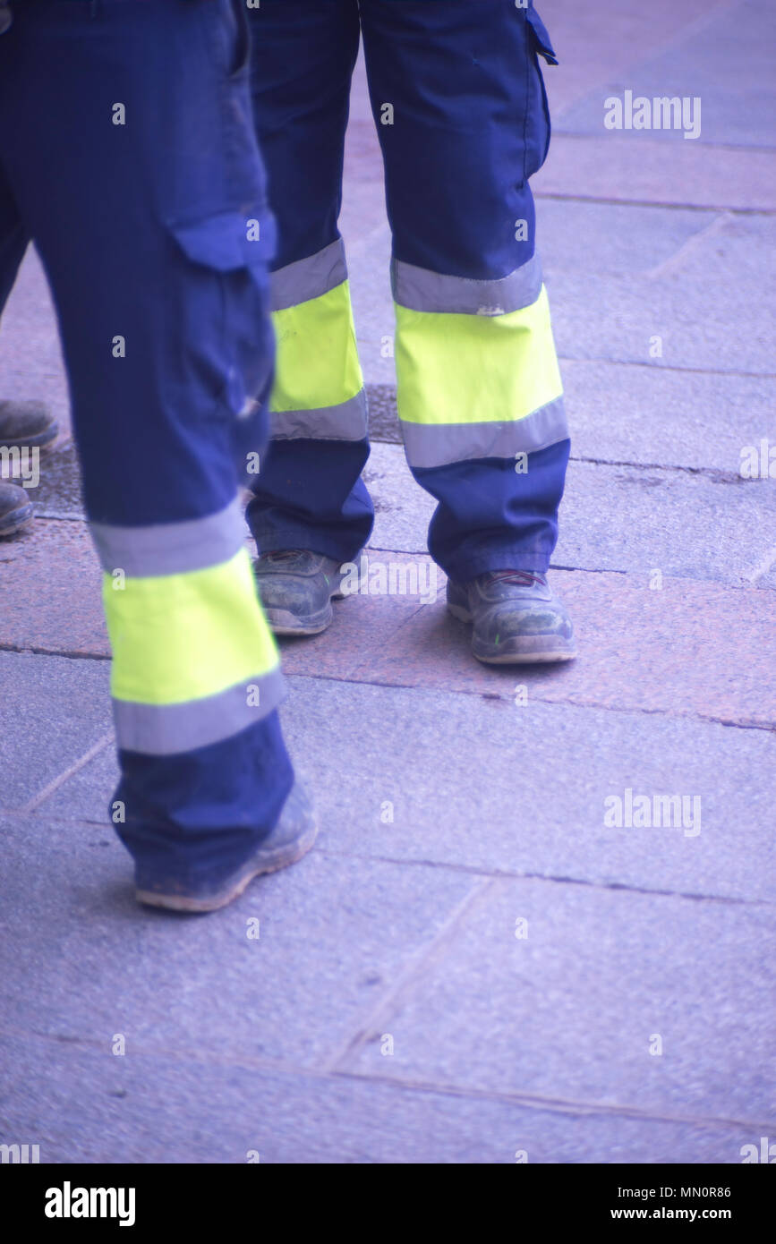Municipal workers on sidewalk pavement standing in work uniform with ...