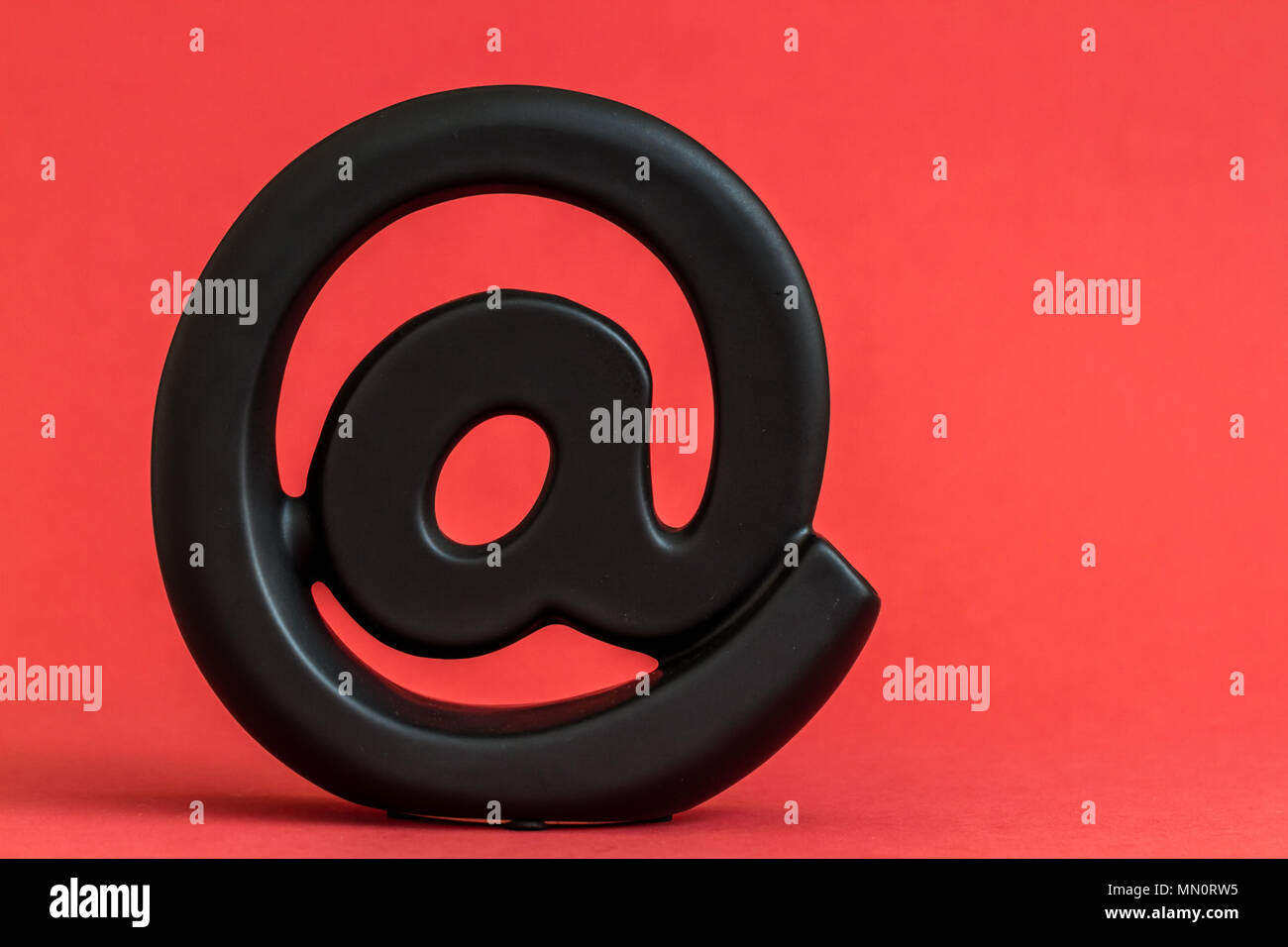 Decorative black email symbol on red background Stock Photo - Alamy