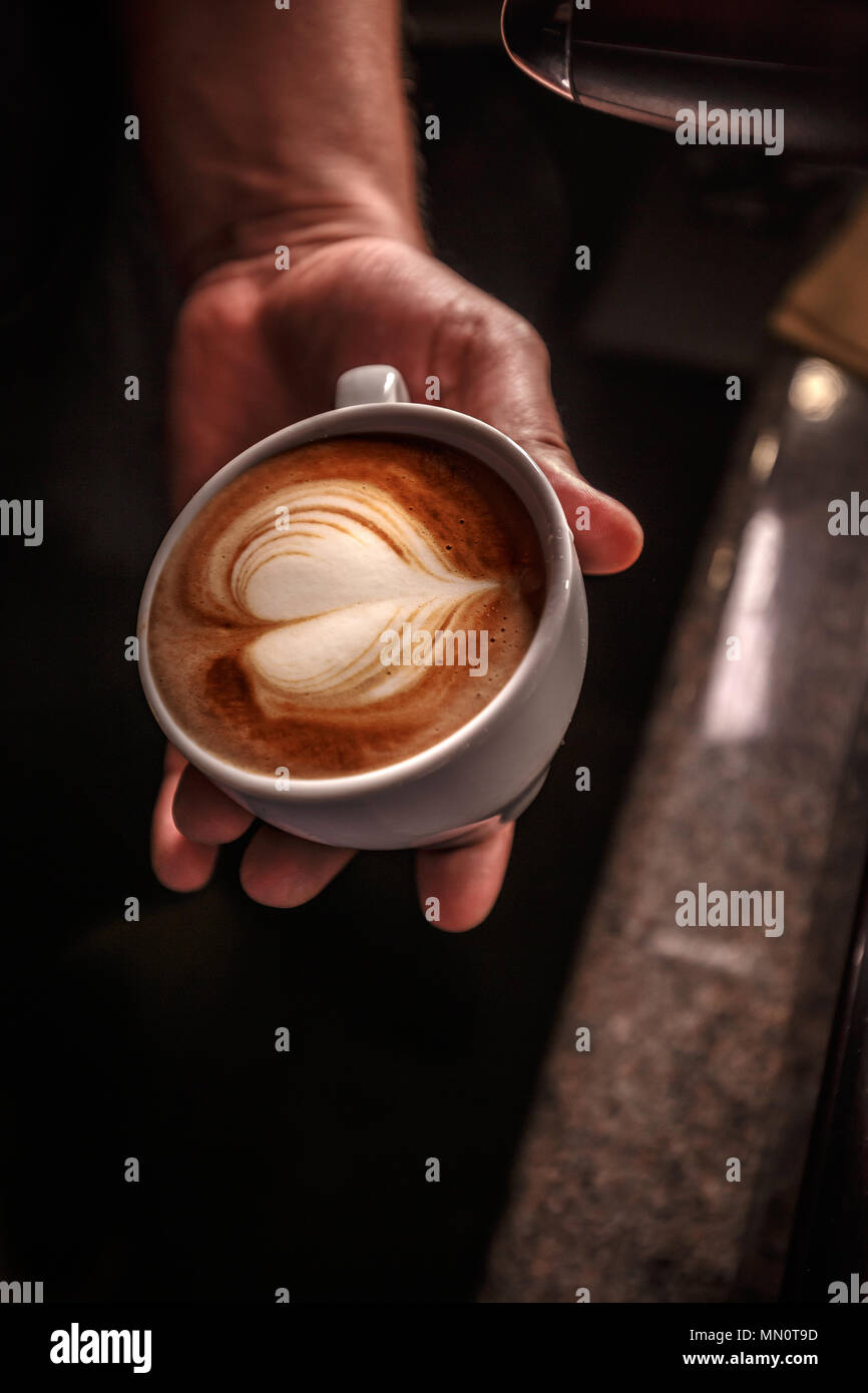 Barista create latte art in coffee shop. Coffee service concept Stock ...