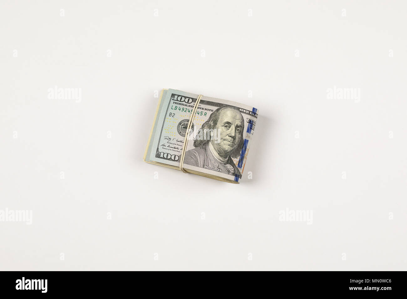 Stack of USA 100 dollars isolated on white background Stock Photo - Alamy