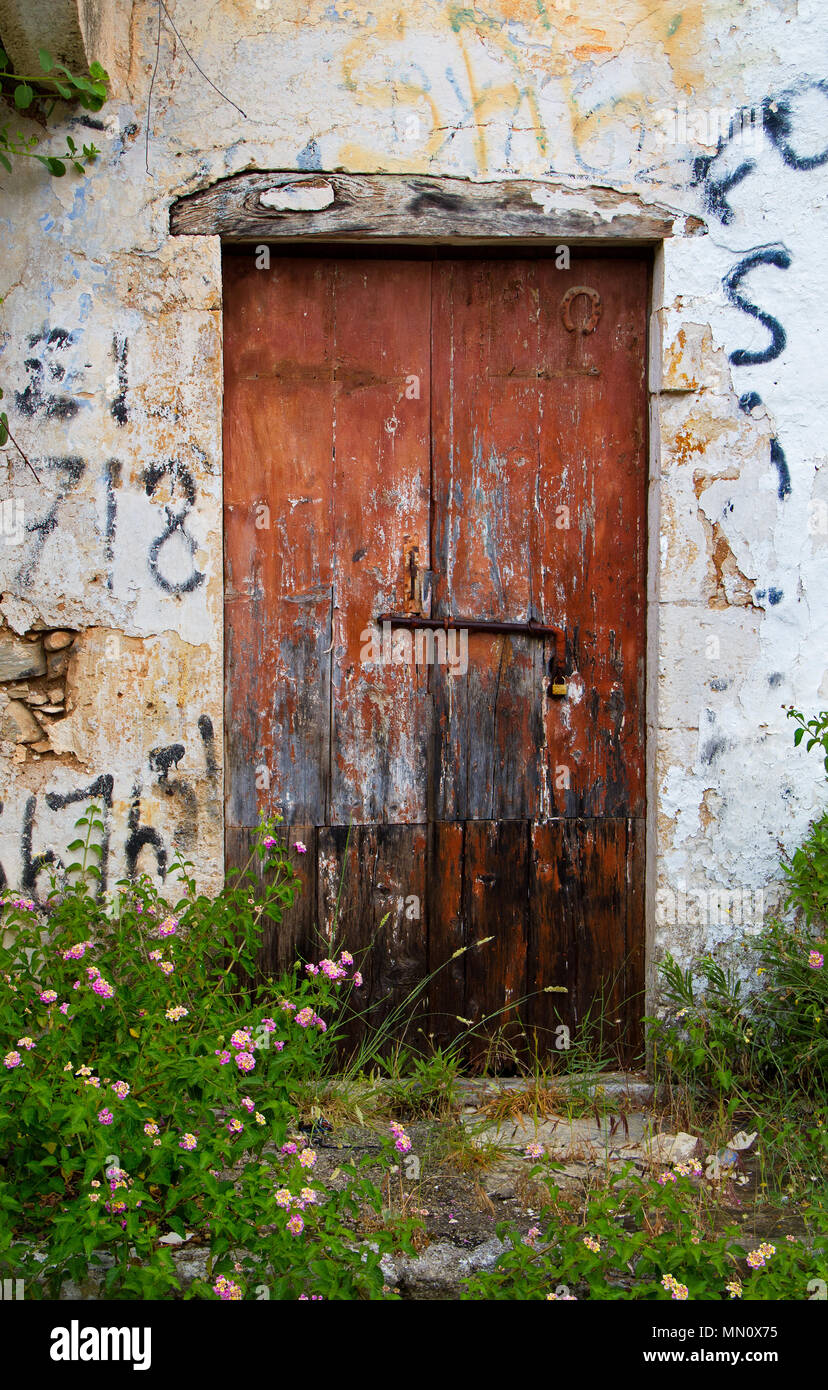 Weathered door of a house, ruined by the 1953 earthquake, in Assos on ...