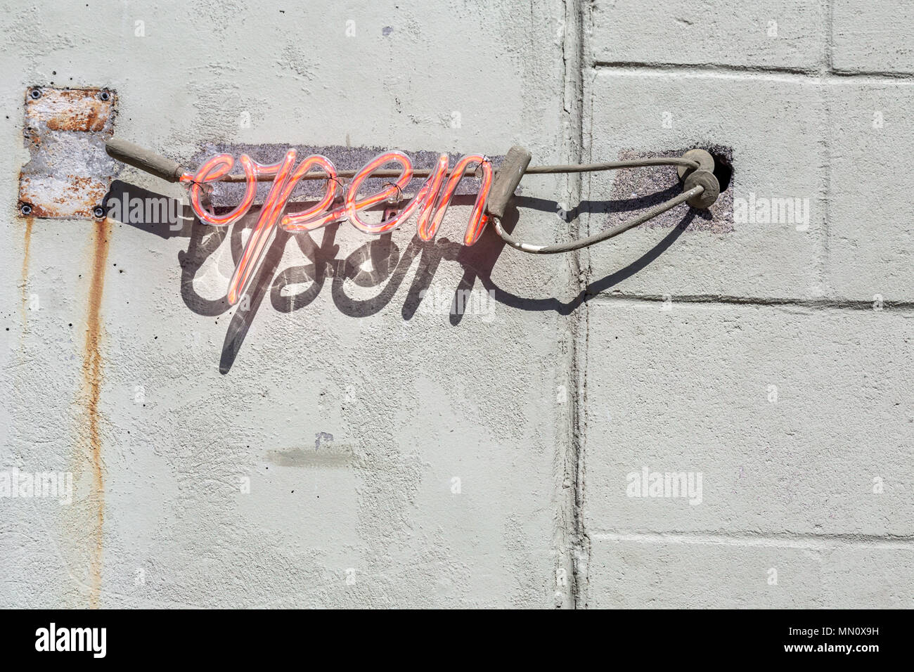 red neon sign that says open in script Stock Photo - Alamy