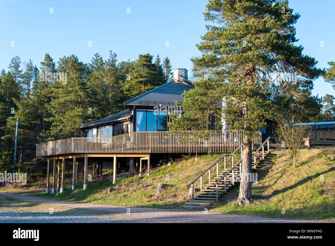 Modern design wooden house on top of a mountain surrounded by trees ...