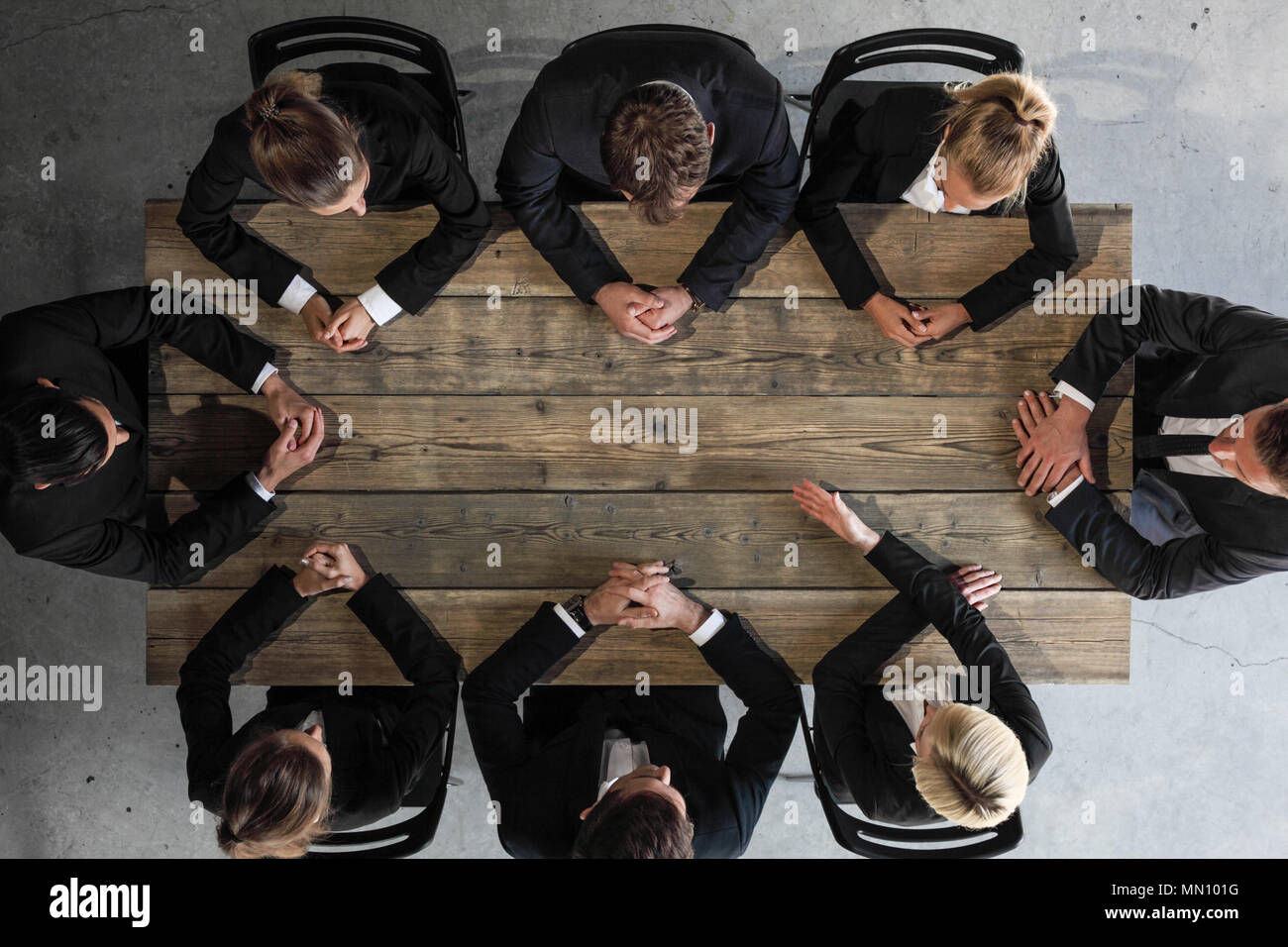 Business meeting concept, people in formal wear sitting around wooden ...