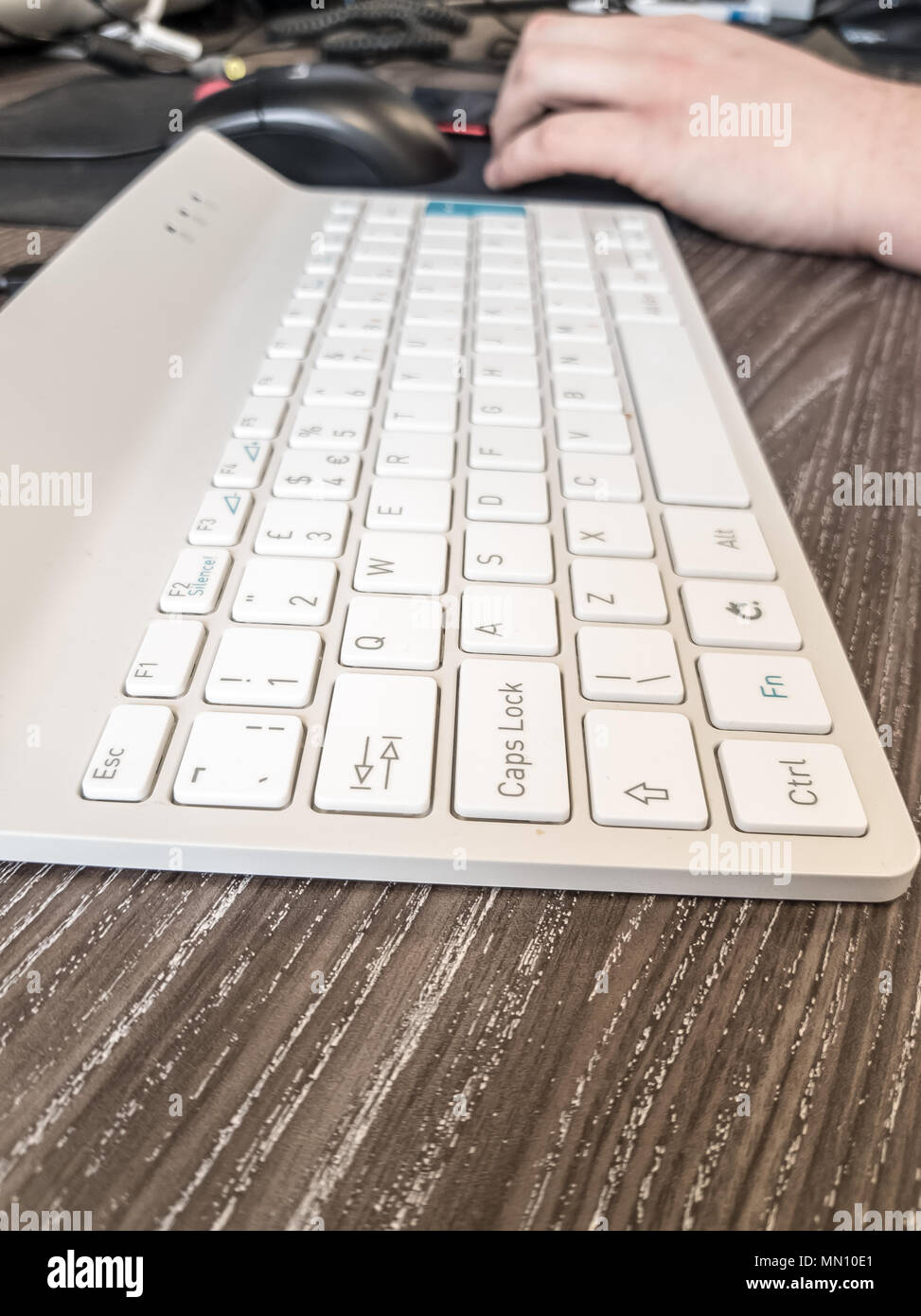 White keyboard and a mouse on computer table Stock Photo - Alamy