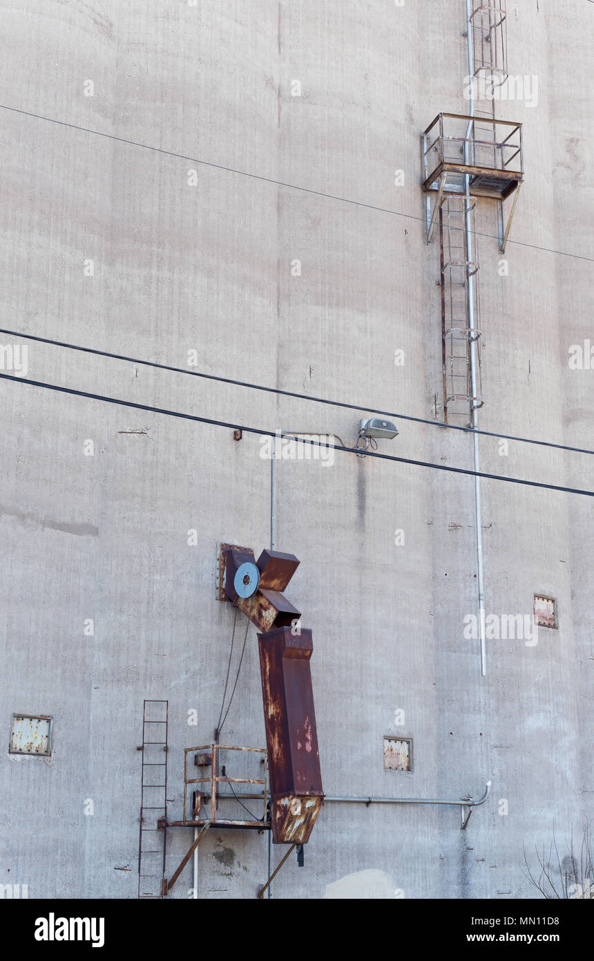 grain silo chute and ladder with platform isolated against gray ...