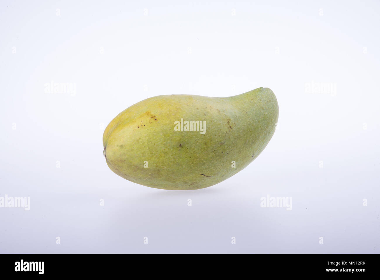 mangos or green yellow mangos on background Stock Photo - Alamy