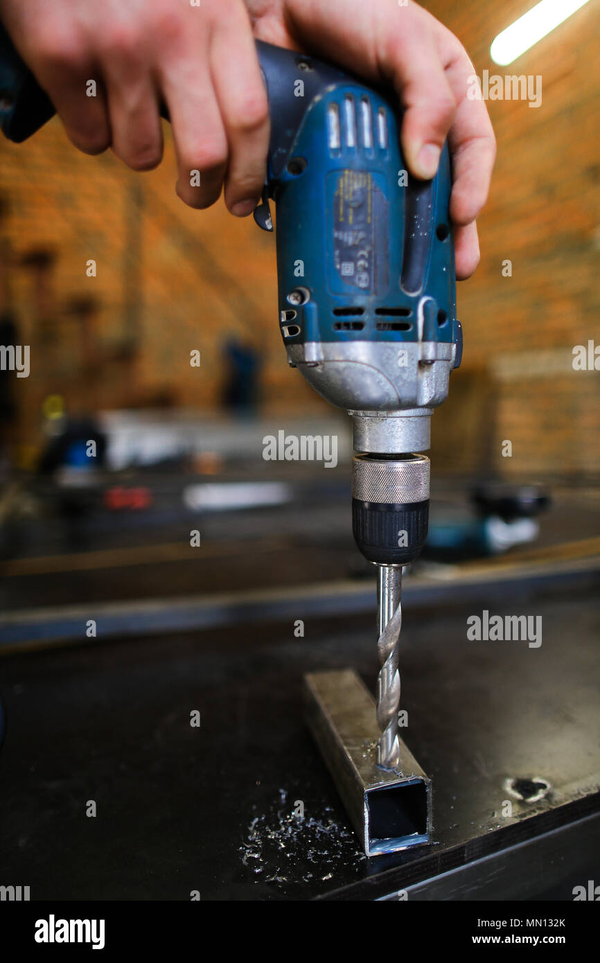 Close up blue electrical drill drilling metall construction Stock Photo ...