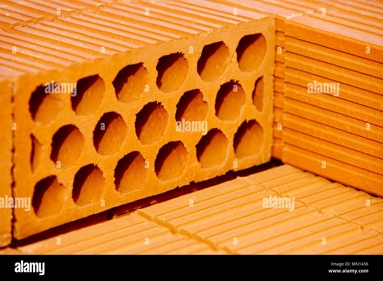 Stacked orange bricks. Construction industry. Building pieces ...
