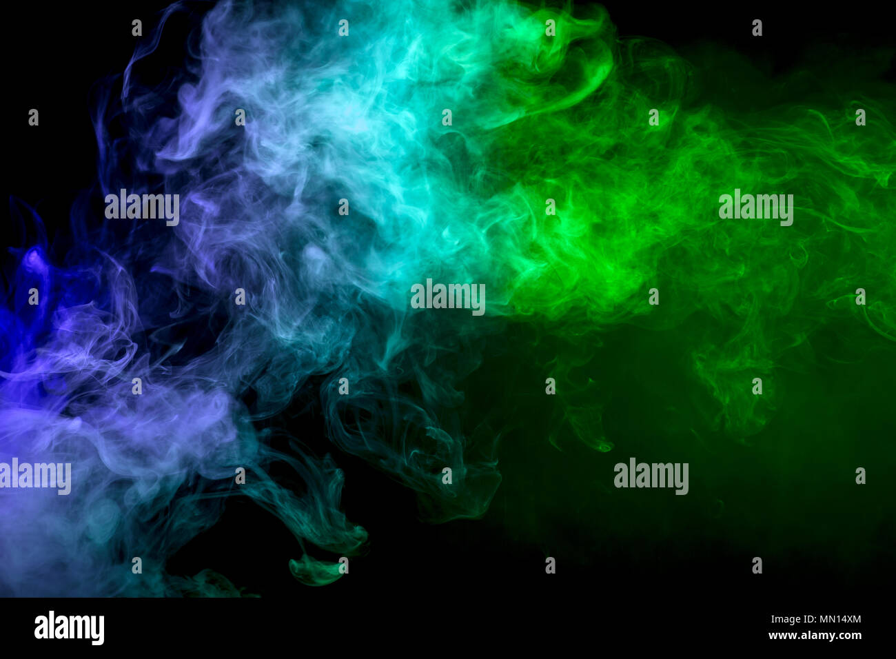 Colorful blue and green smoke on a black isolated background ...