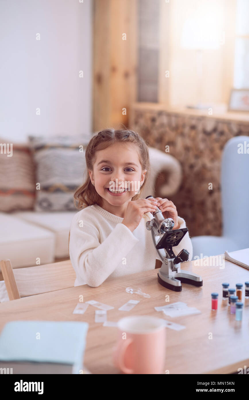 Cheerful smart girl smiling to you Stock Photo - Alamy