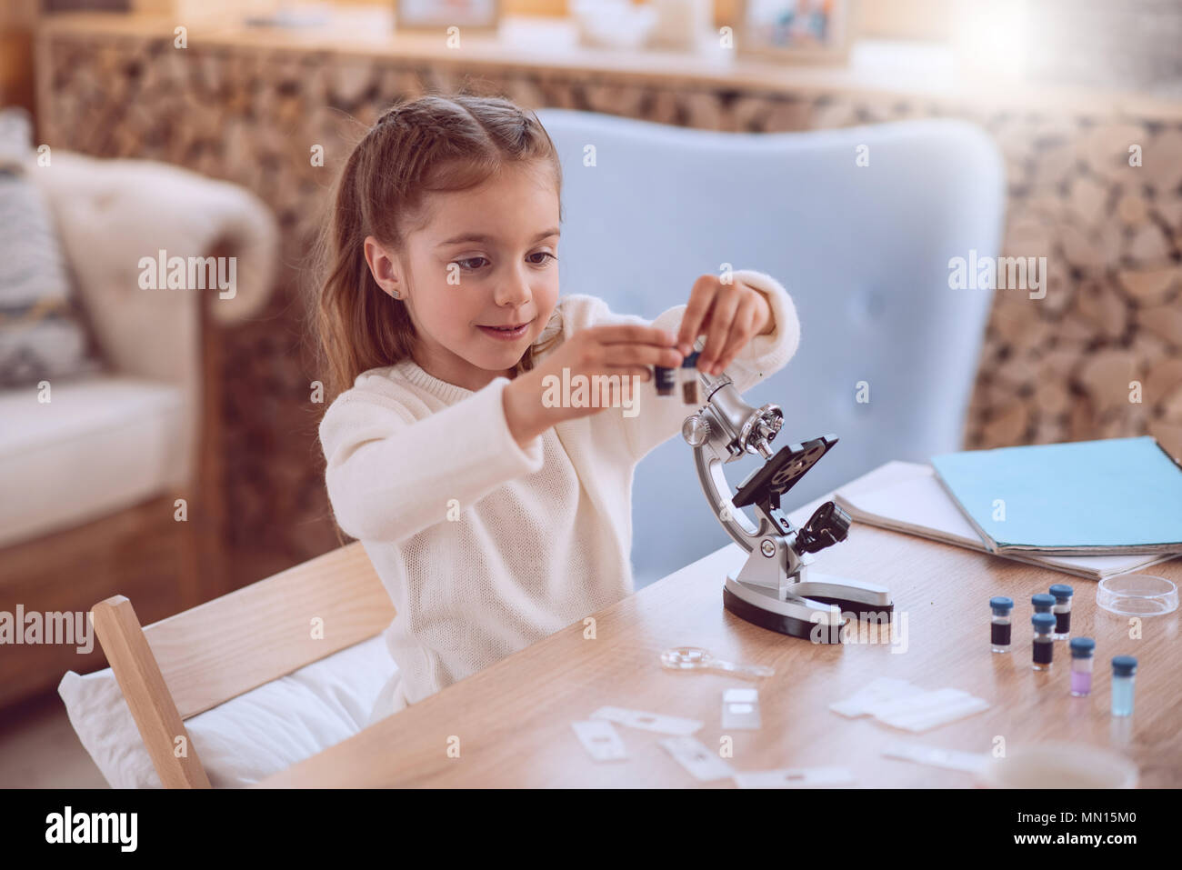 Nice joyful girl using the microscope Stock Photo - Alamy