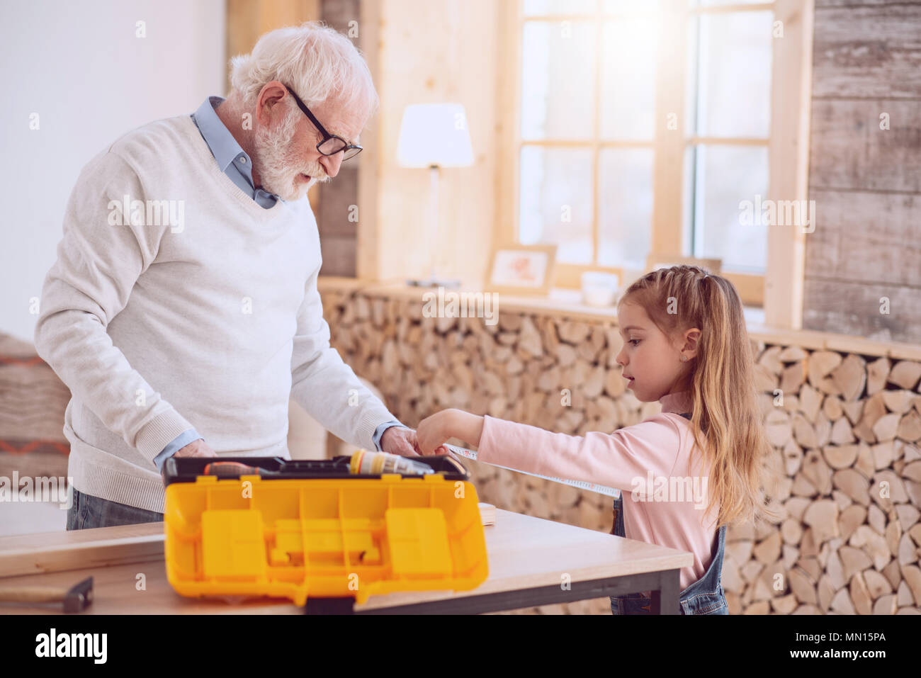 Child helping elderly hi-res stock photography and images - Alamy