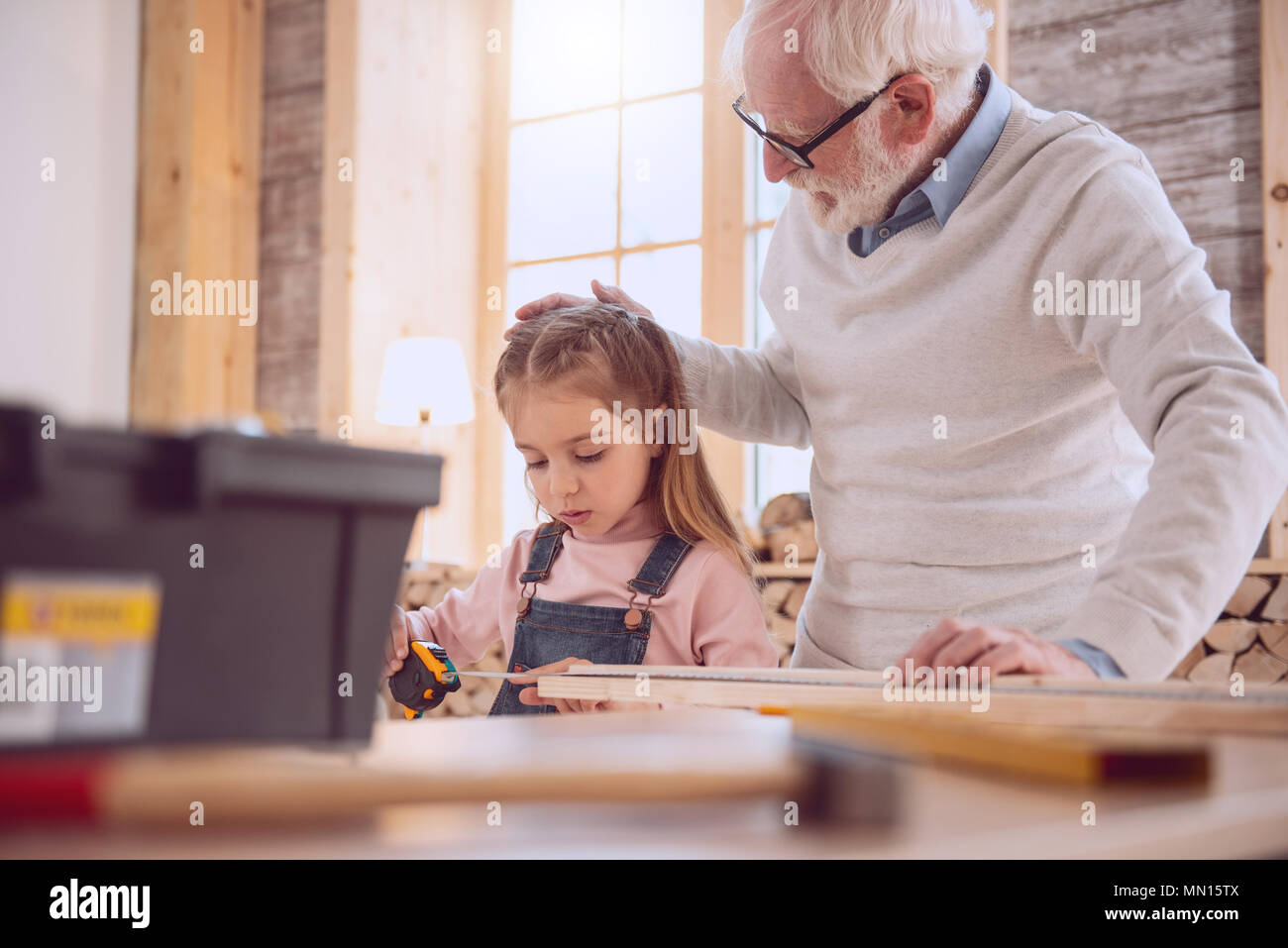Serious pretty girl holding a tape measure Stock Photo - Alamy