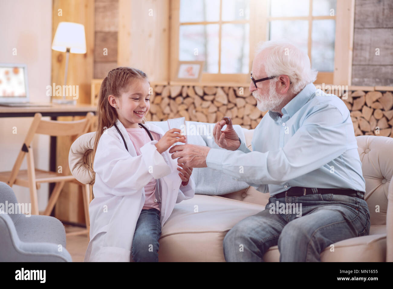 Happy positive girl wearing doctors uniform Stock Photo - Alamy