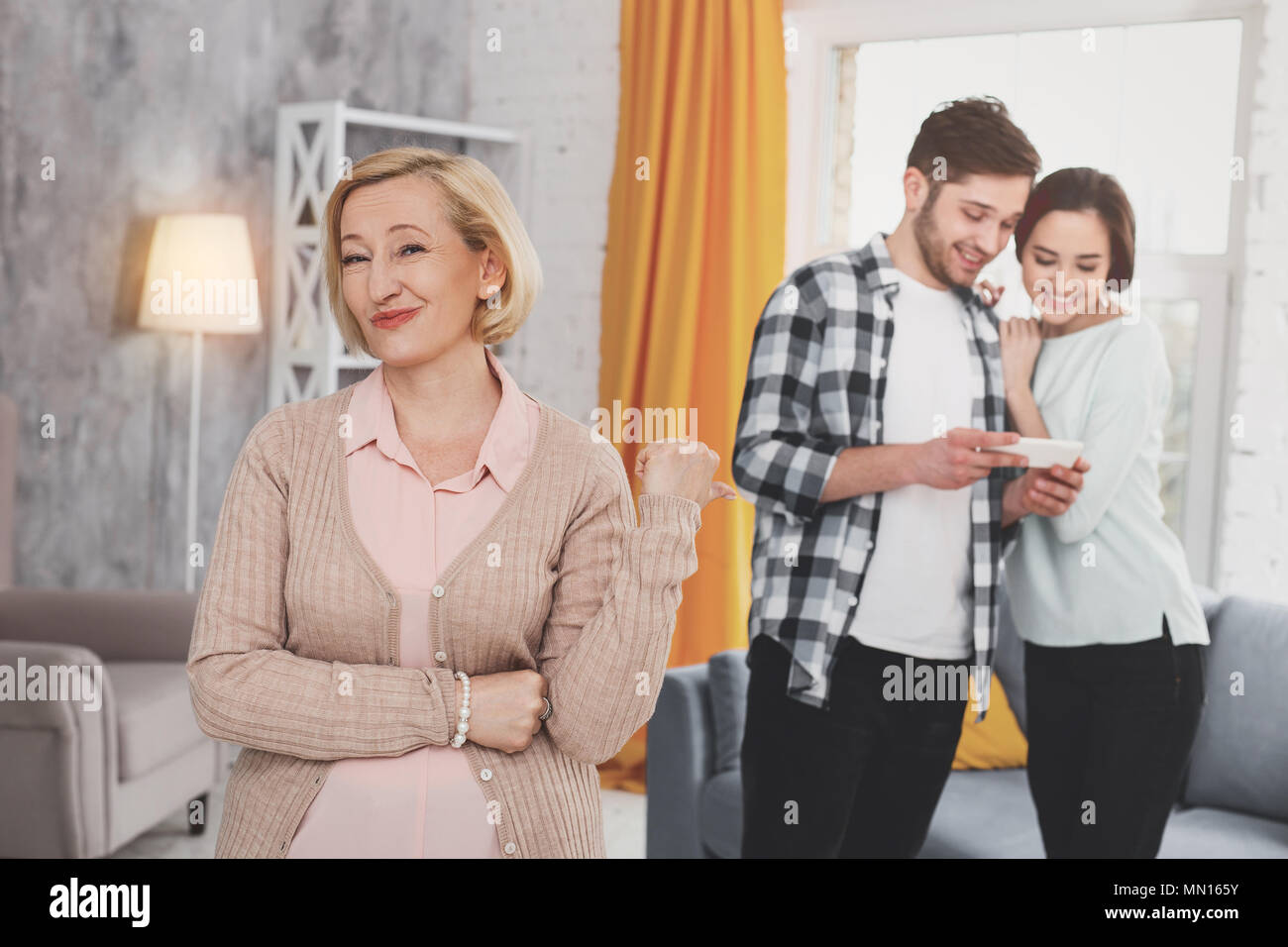 Aged elderly woman pointing at the couple Stock Photo - Alamy