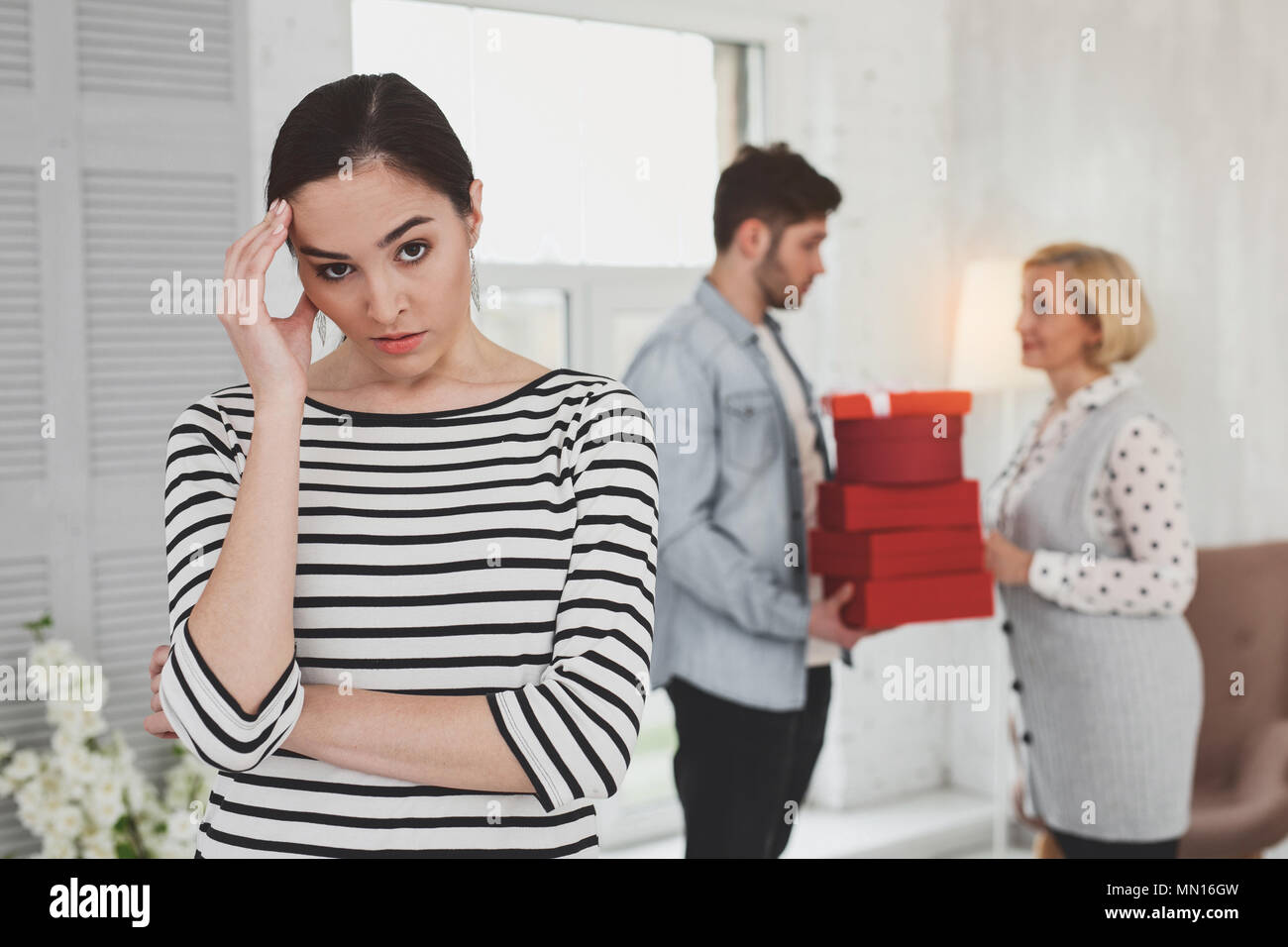 Cheerless sad woman touching her temple Stock Photo - Alamy