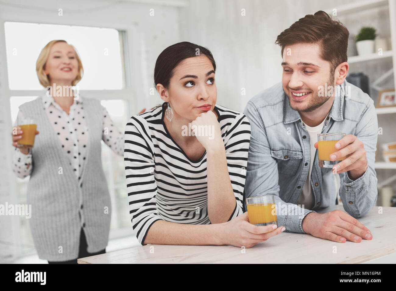 Nice young couple living together with the mother Stock Photo - Alamy