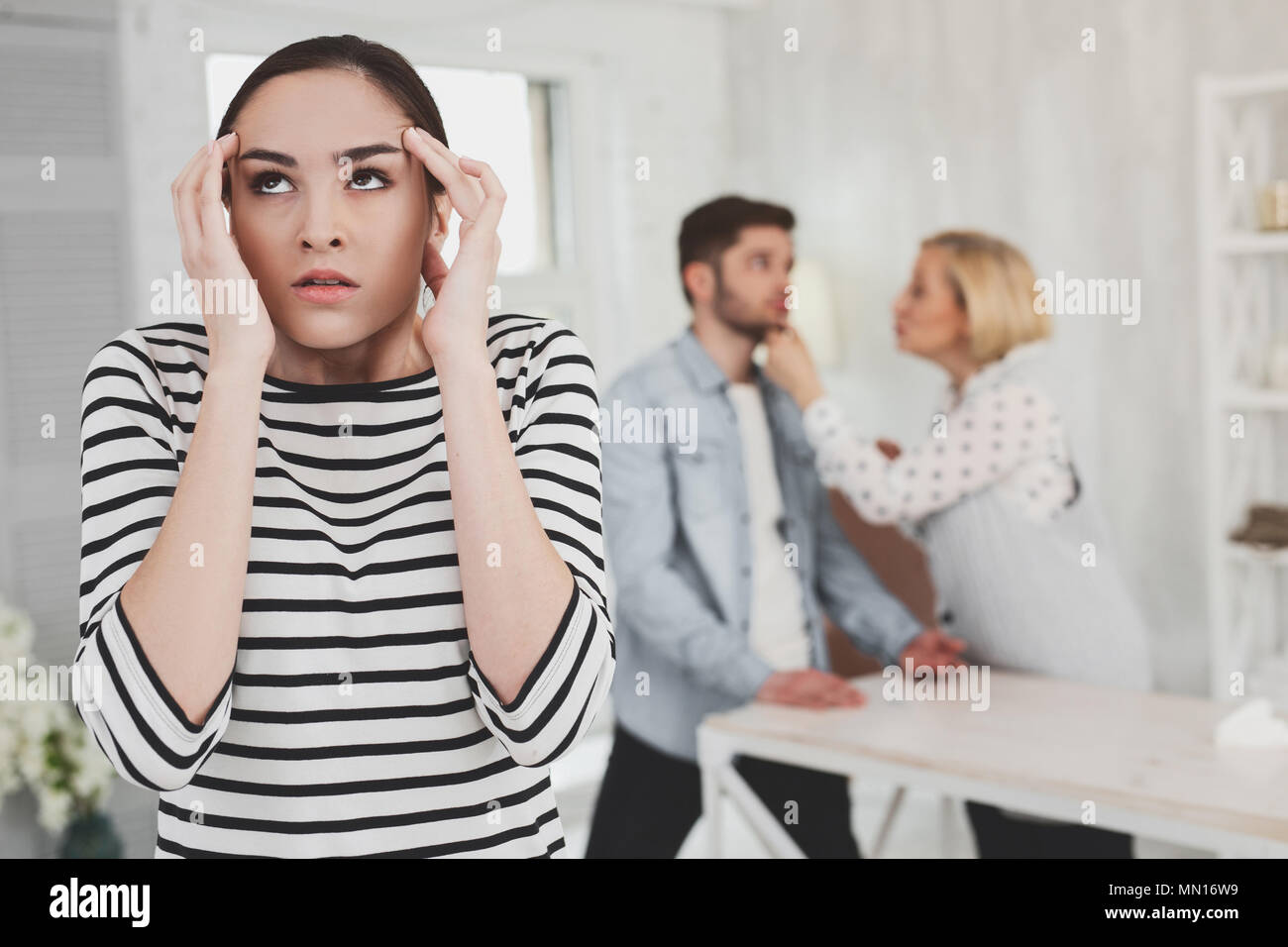 Cheerless young woman rolling her eyes Stock Photo - Alamy