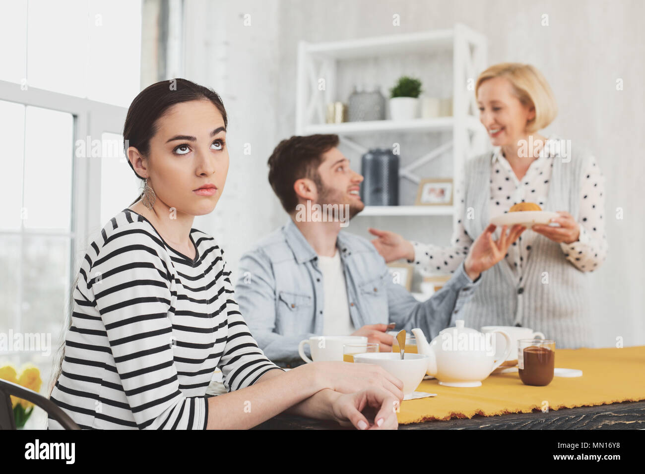 Cheerless young woman rolling her eyes Stock Photo - Alamy