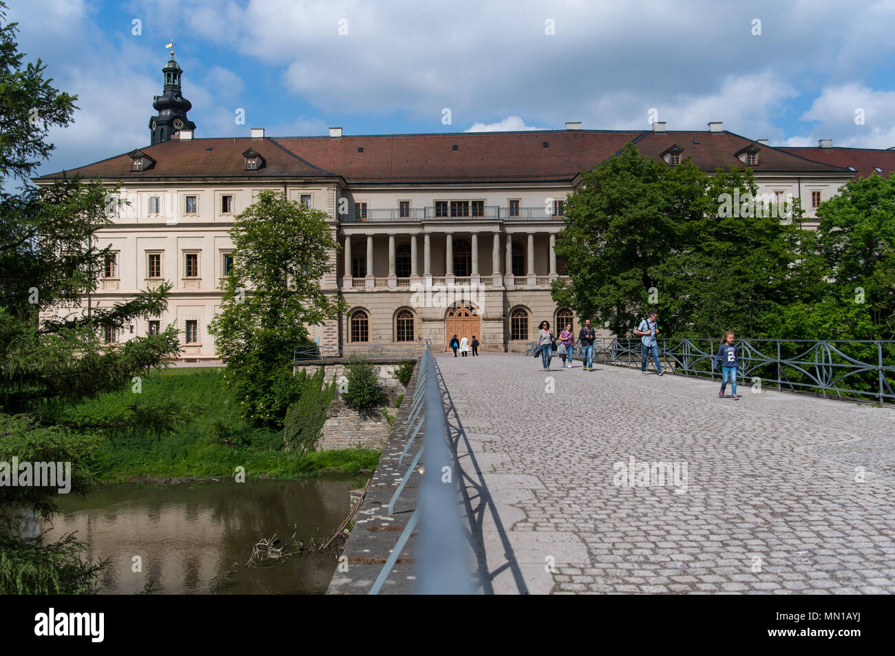 11 May 2018, Germany, Weimar: Tourists walk across a bridge in front of ...