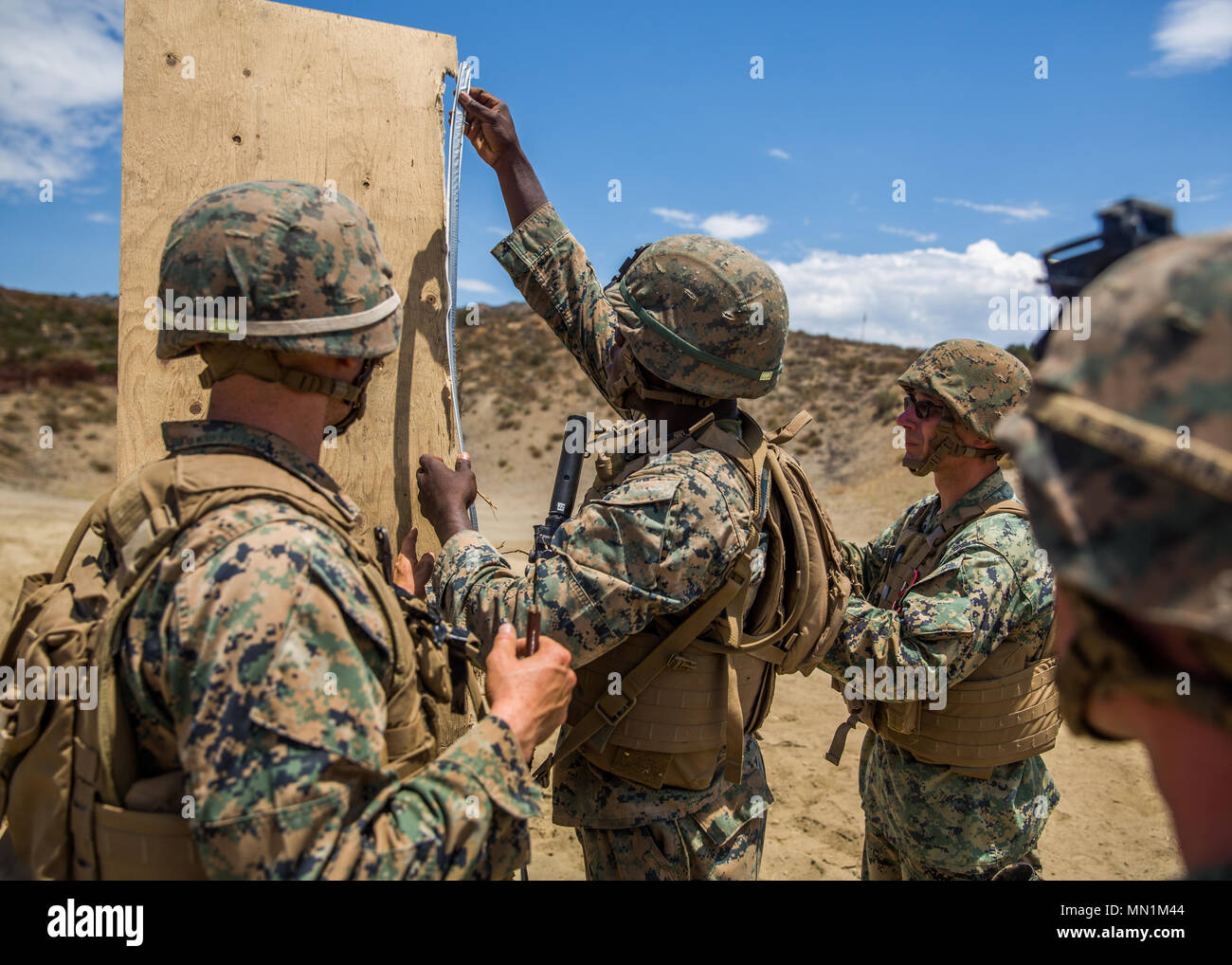Door breaching charge is an explosive device configured to create an ...