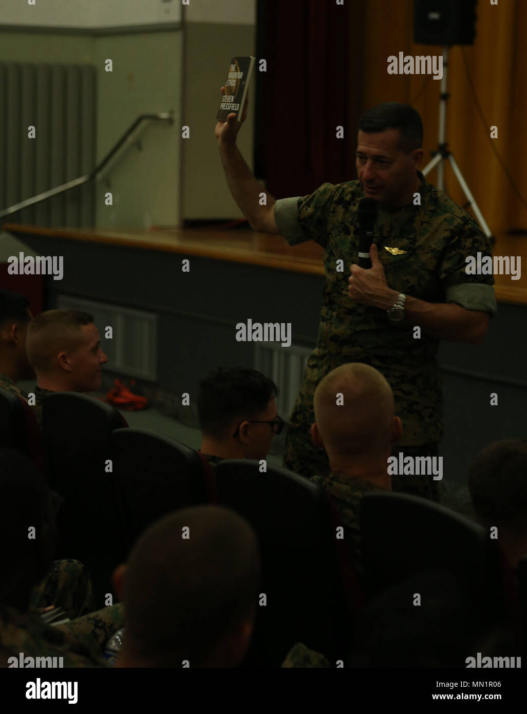 CAMP FOSTER, OKINAWA, Japan – Sgt. Maj. Anthony Spadaro holds up “The ...