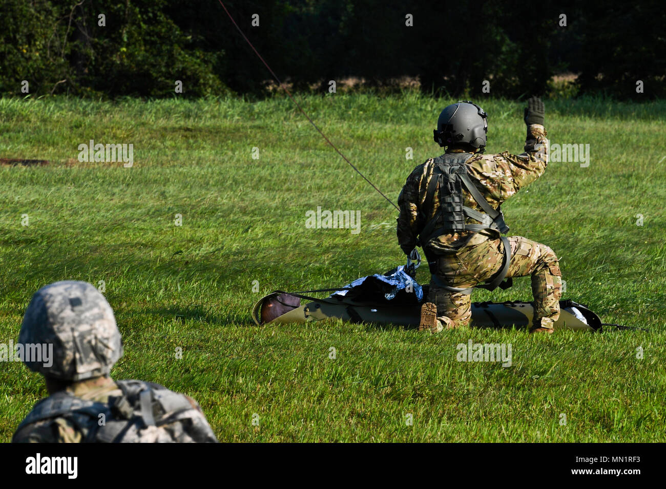 A flight medic assigned to 6-101 GSAB signals the helicopter to begin ...
