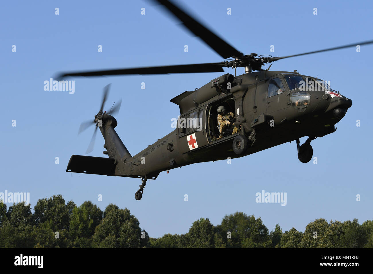 A HH-60 Blackhawk helicopter hovers during medical training Stock Photo ...