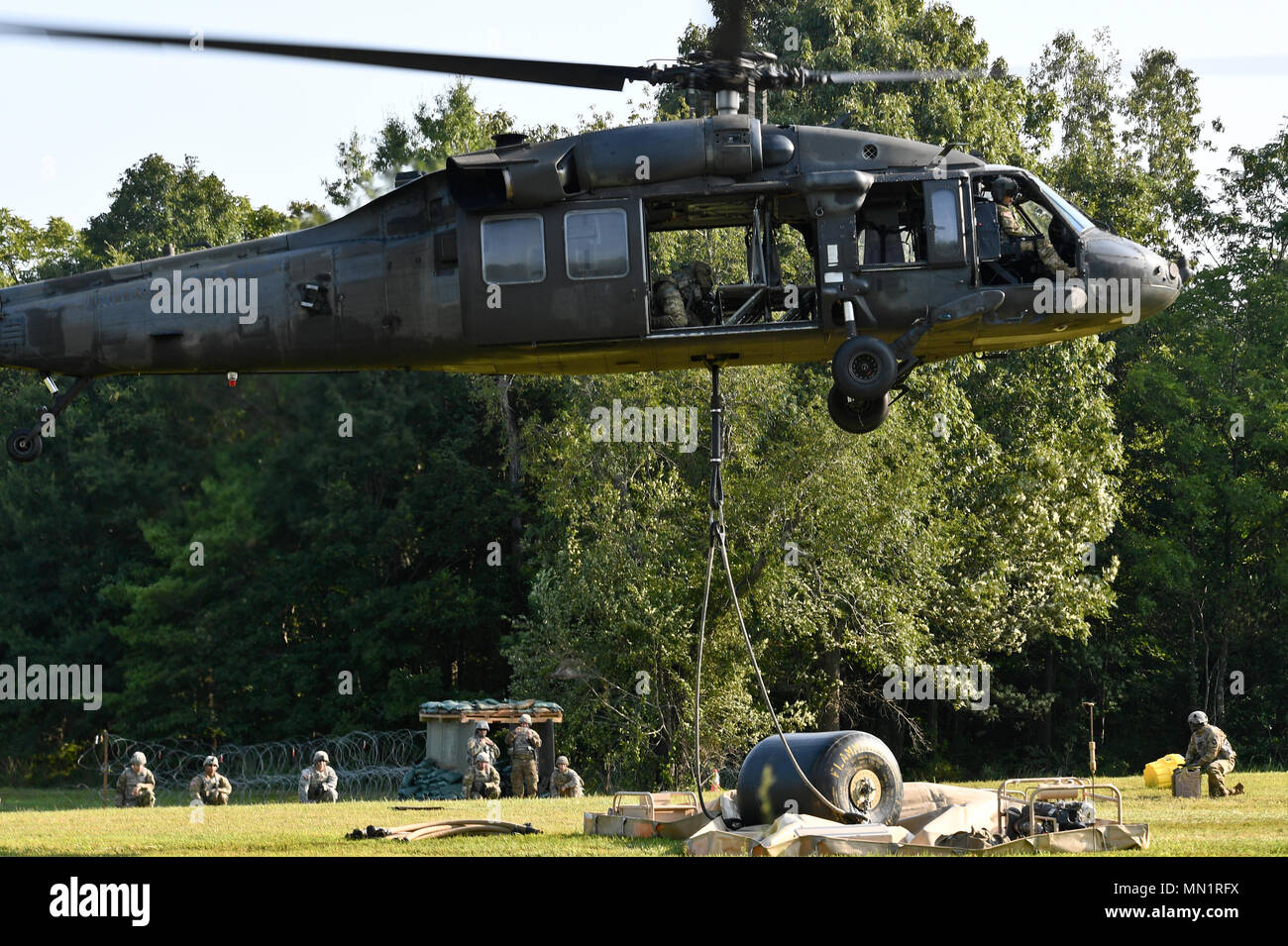 A fuel blivet is delivered by a Blackhawk helicopter assigned to 6-101 ...