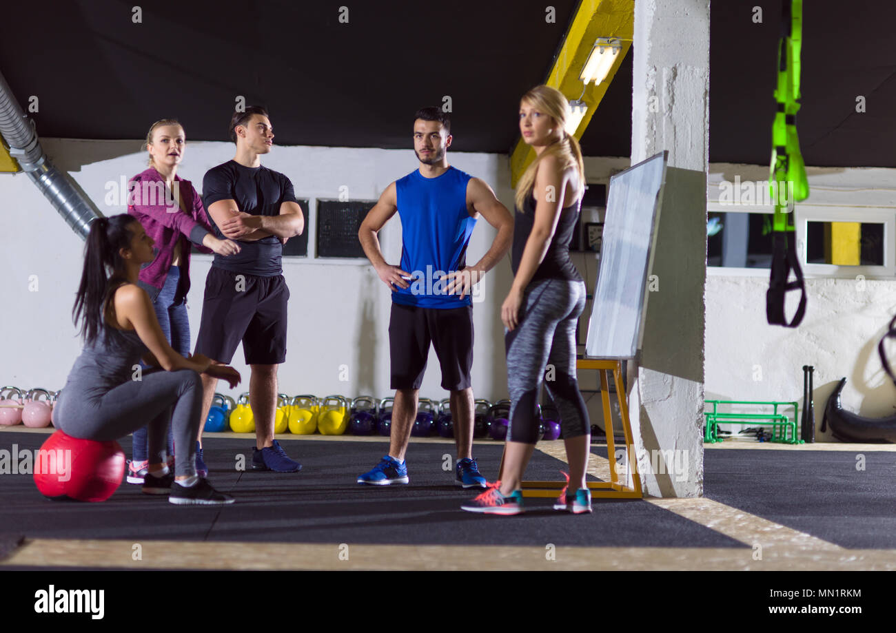 Crossfit training course.group of young athletes getting instructions ...