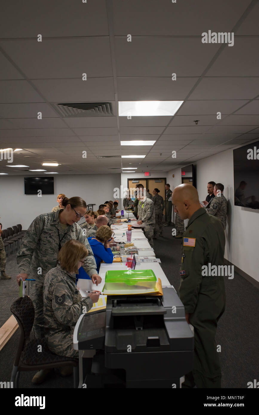 Airmen with the 153rd Airlift Wing process through a personnel ...